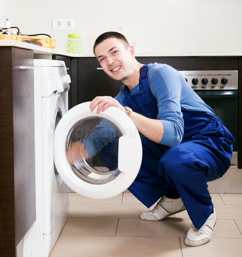 Washing machine repairman stock photo. Image of equipment - 31649500
