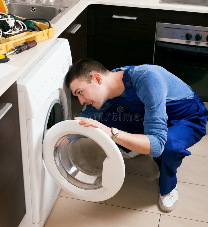 Technician Repairing Washing Machine while Gesturing Thumbs Up Stock ...