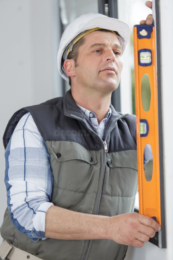 Repairman Using Builder Level Stock Photo - Image of level, foreman ...