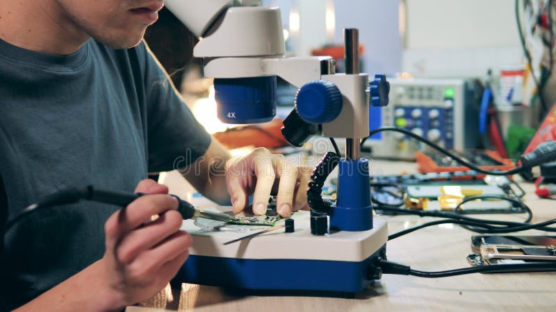 Repairman is Using a Microscope while Fixing a Circuit Stock Footage ...