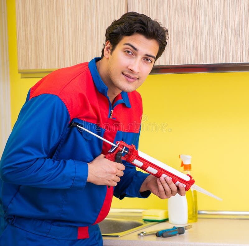 Repairman Working in the Kitchen Stock Photo - Image of caulking ...