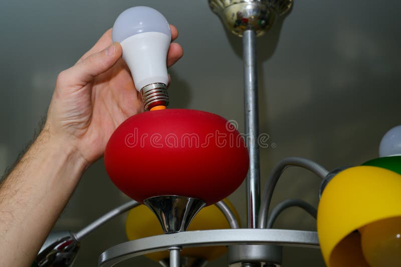 Replacing the Light Bulb in the Chandelier. LED Lamp. Stock Photo ...