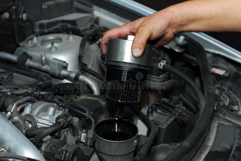Replacement of oil filter stock image. Image of automotive - 72780925