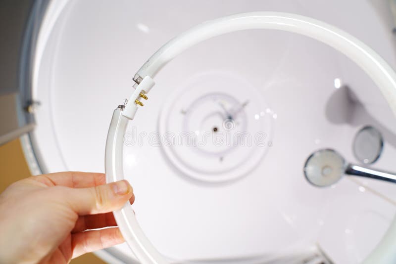 Replacement of an Old Fluorescent Lamp with a Ring LED Module. Stock ...