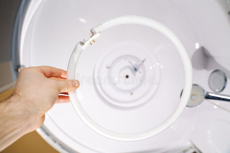 Replacement of an Old Fluorescent Lamp with a Ring LED Module. Stock ...