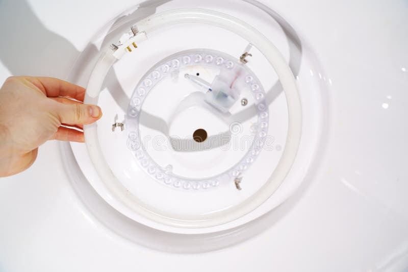 Replacement of an Old Fluorescent Lamp with a Ring LED Module. Stock ...