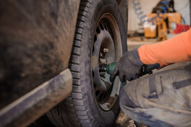 Replacement and Repair of Wheels and Shock Absorbers on a Car in a ...