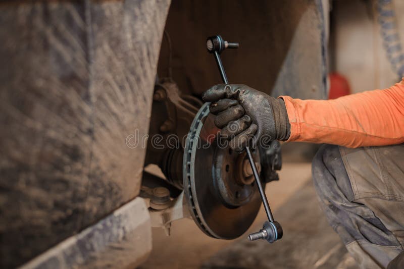 Replacement and Repair of Wheels and Shock Absorbers on a Car in a ...