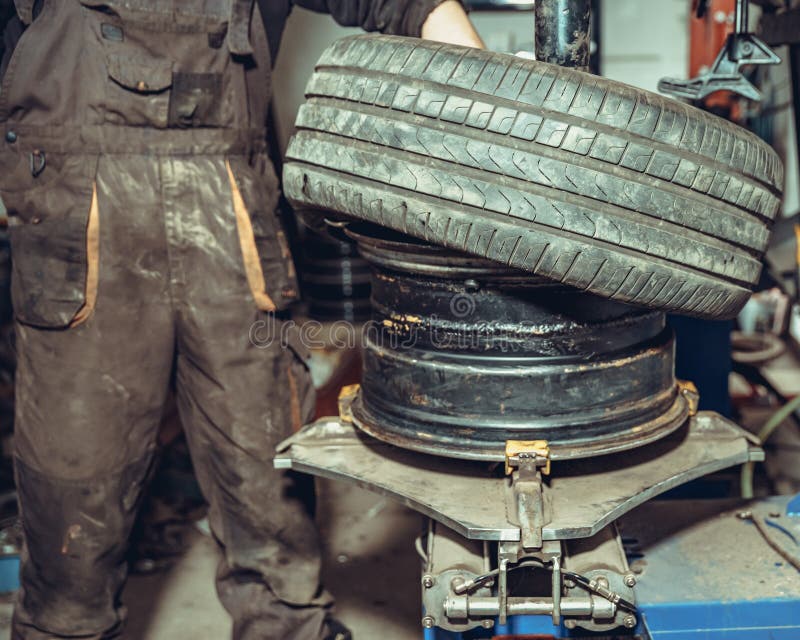 Replacement of Tires on the Wheels of the Car in the Service Stock ...