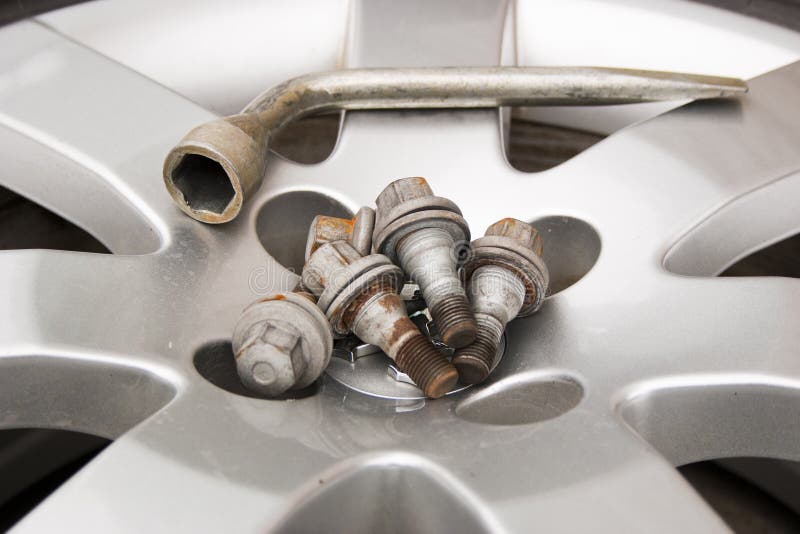 Replacing a car wheel stock image. Image of installation - 165588641