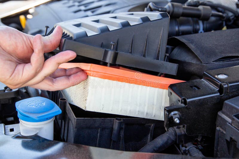 Replacing an Old Dirty Air Filter in the Engine Compartment of a Car ...
