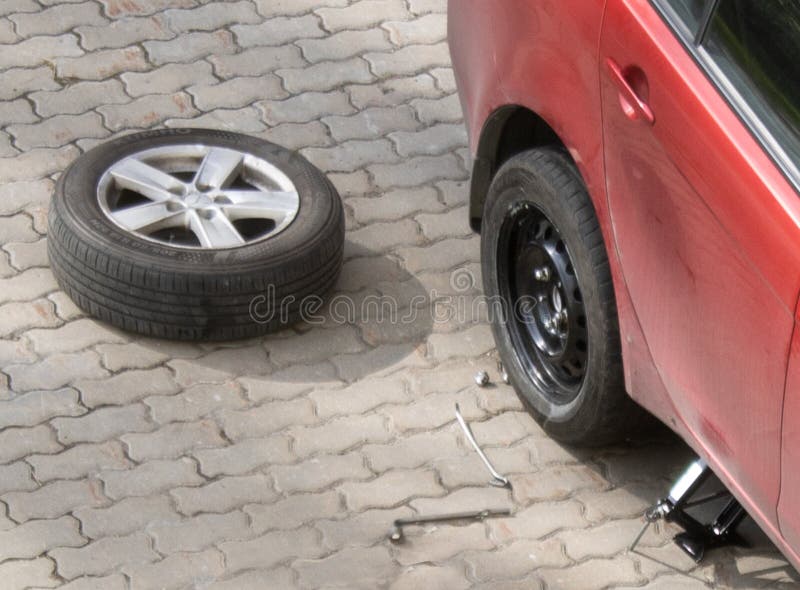 Replacing a Car Wheel with a Jack and Special Keys Stock Image - Image ...