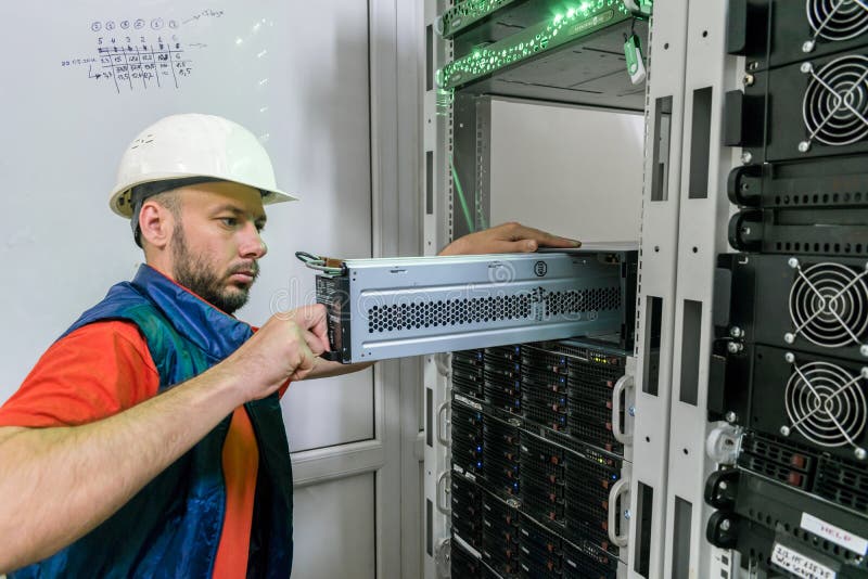 The Technician Installs a New Battery Pack into the Uninterruptible ...