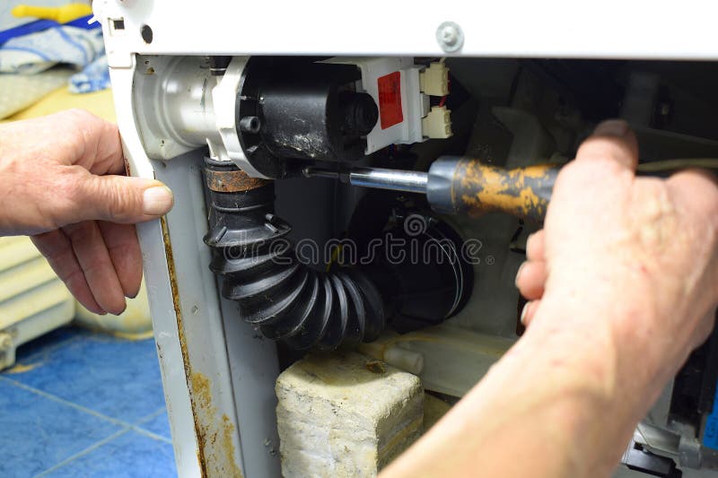 Replacing the Pump in a Washing Machine Stock Photo - Image of hand ...