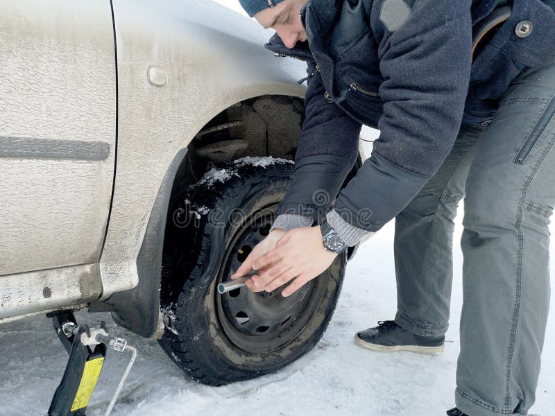 Punched and Flat Tire on the Road. Replacing the Wheel with a Jack by ...