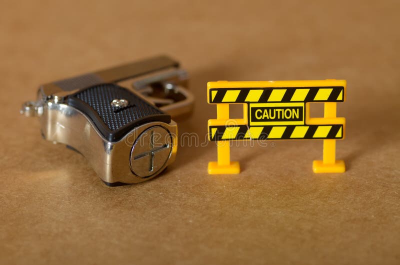 Replica Handgun Against Caution Barrier â€ Symbol of Safety and ...