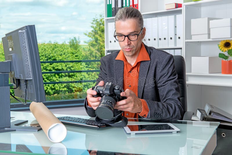 Reporter Working in Editorial Office with Computer and Camera Stock ...