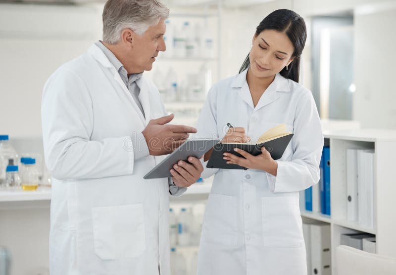 Reporting on the Latest Case To the Lab Manager. Two Scientists Using a ...