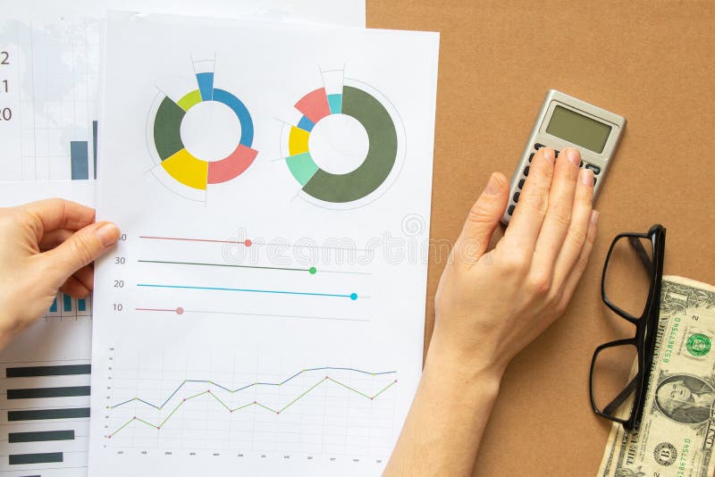 Reports and Histograms on Paper on the Table in the Hands of a Girl ...