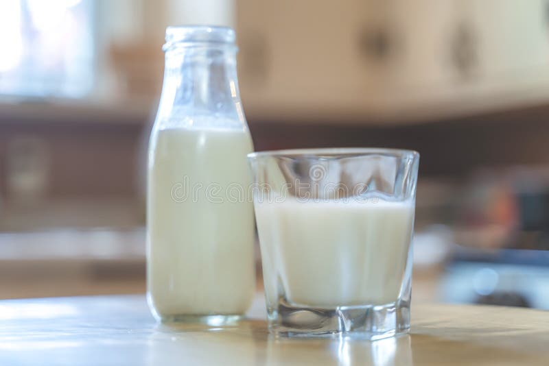 Reptientes with Milk on a Wooden Table and Rustic Kitchen Background ...