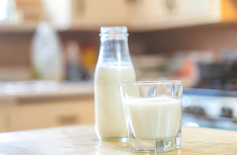 Reptientes with Milk on a Wooden Table and Rustic Kitchen Background ...