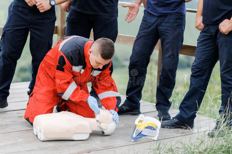 Rescue Team. the Man Shows the Provision of First Aid in the ...