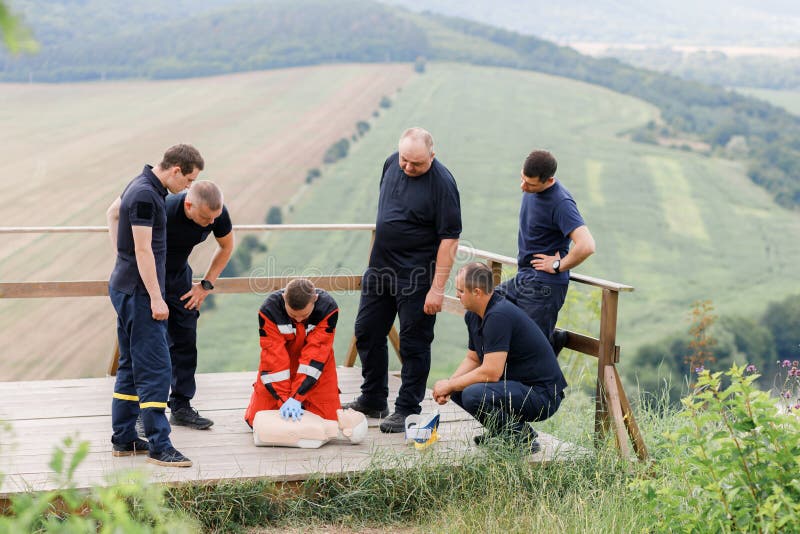 Rescue Team. the Man Shows the Provision of First Aid in the ...