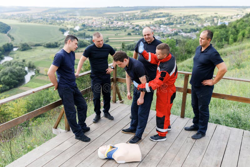Rescue Team. the Man Shows the Provision of First Aid in the ...
