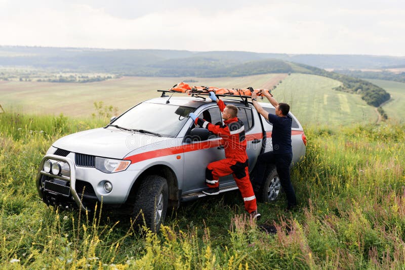 Rescue Team. the Man Shows the Provision of First Aid in the ...