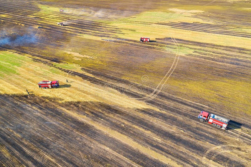 Rescuers Came To Extinguish a Fire in an Open Field Stock Image - Image ...