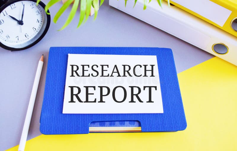 Research Report Text Written on a White Paper Above a Notebook with ...