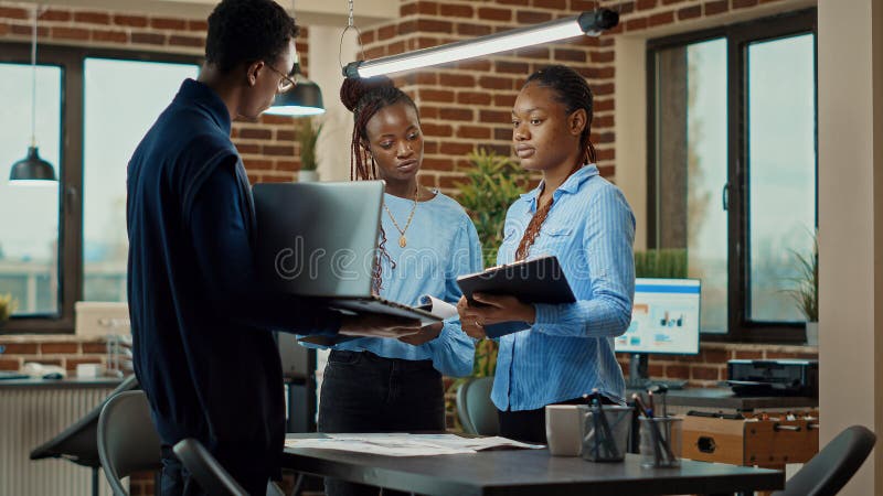 Research Team Reviewing Data Reports Stock Photo - Image of businessman ...