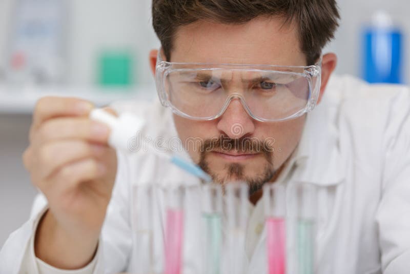Research Worker Doing Experiments with Chemical Liquid at Laboratory ...