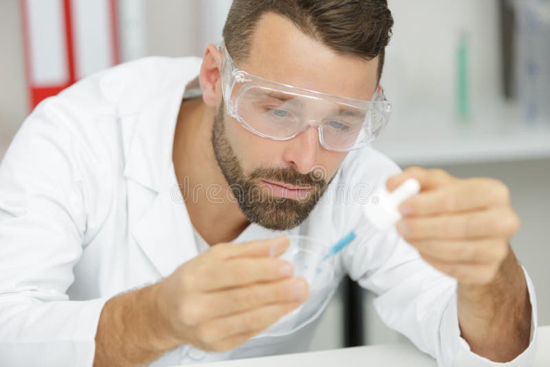 Research Worker Doing Experiments with Chemical Liquid at Laboratory ...