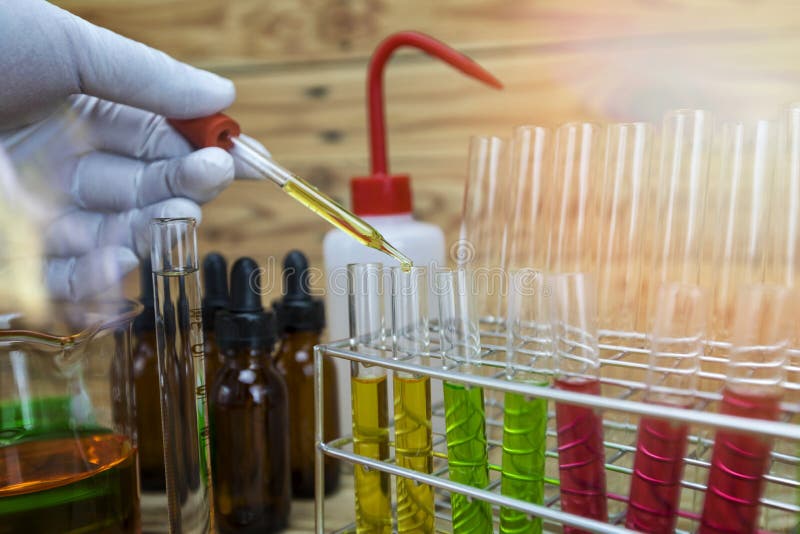 Researcher is Dropping the Reagent into Test Tube.Scientist Working at ...
