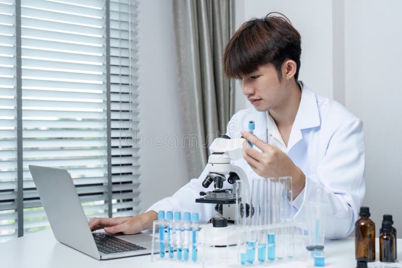 Scientist Analyzing Substance Under Microscope in Modern Laboratory ...