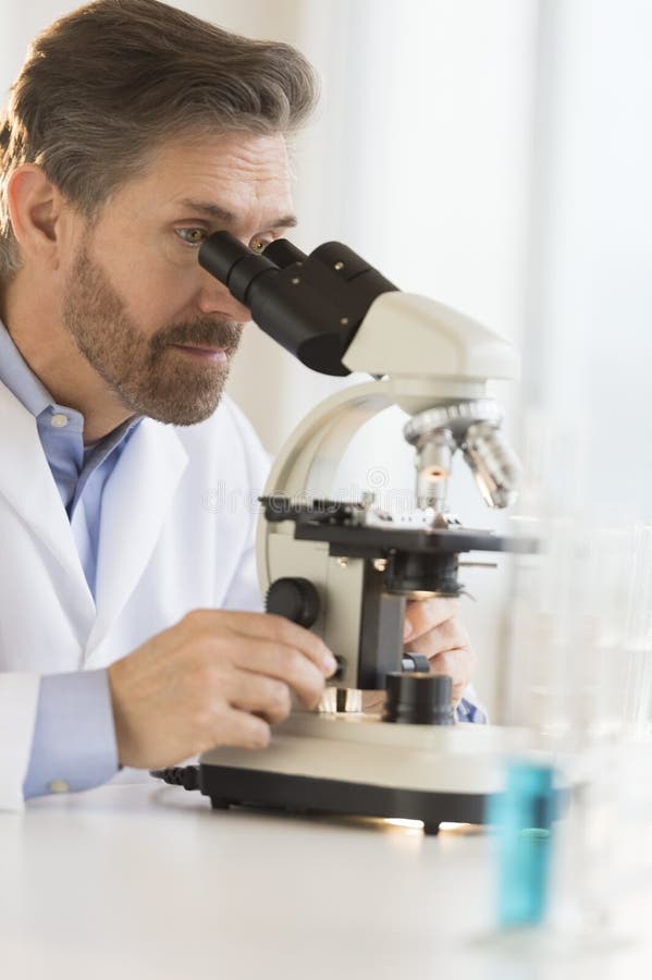 Researcher Looking into Microscope Stock Image - Image of people ...