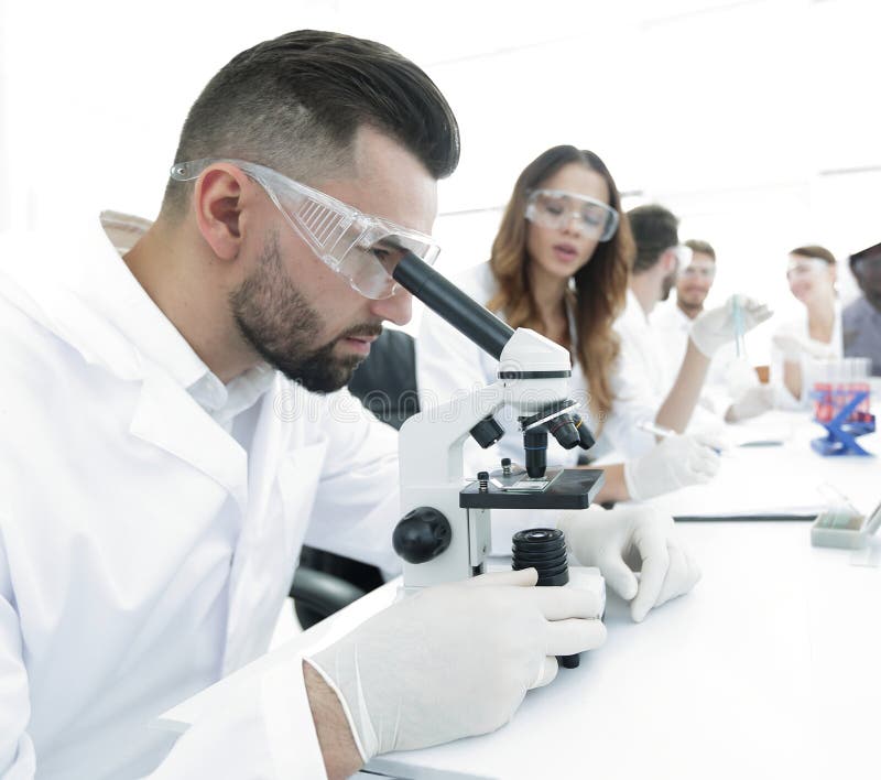 Researcher Looking into a Microscope in a Modern Laboratory Stock Photo ...