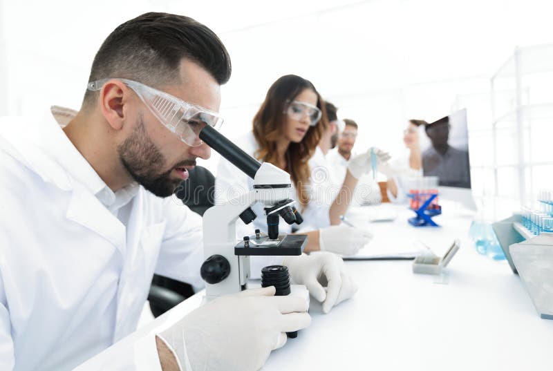 Researcher Looking into a Microscope in a Modern Laboratory Stock Image ...