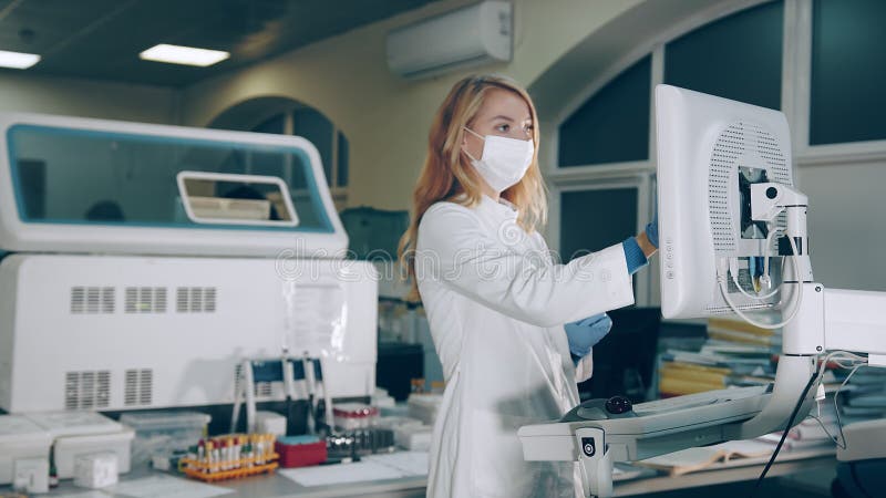Researcher of Microbiology, Working in the Laboratory Presses the Keys ...