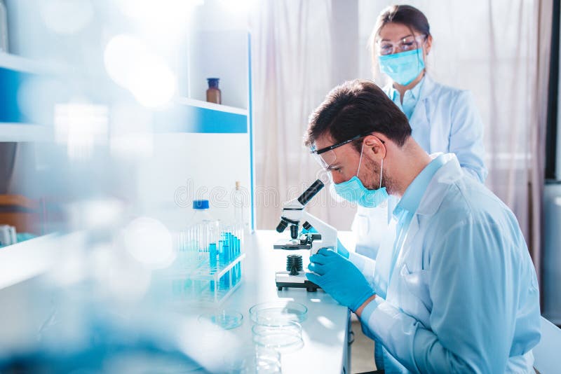 Doctor in the Laboratory Analyzes Samples of Codiv-9 Under a Microscope ...