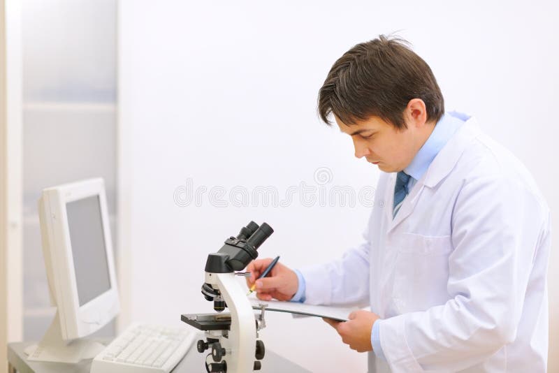Researcher Using Microscope in Laboratory Stock Image - Image of ...