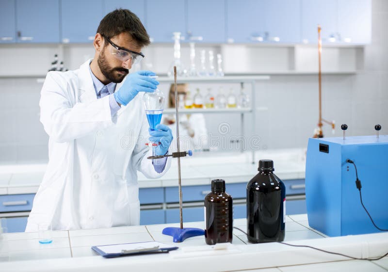Researcher Working with Blue Liquid at Laboratory Glass Stock Photo ...