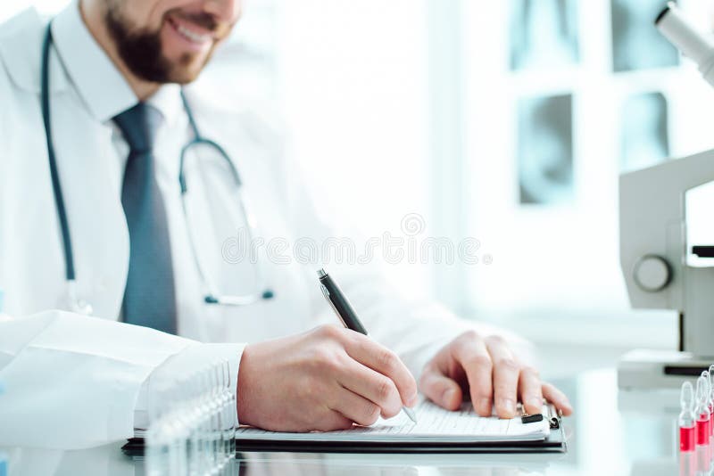 Researcher Writes Down the Results of Research in a Laboratory Journal ...