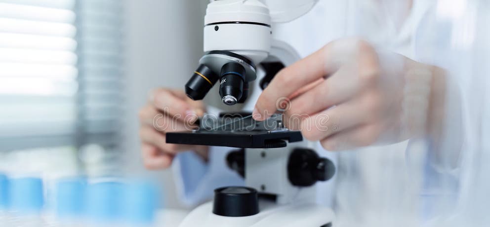 Researchers Analyzing Substance Under Microscope in Modern Laboratory ...