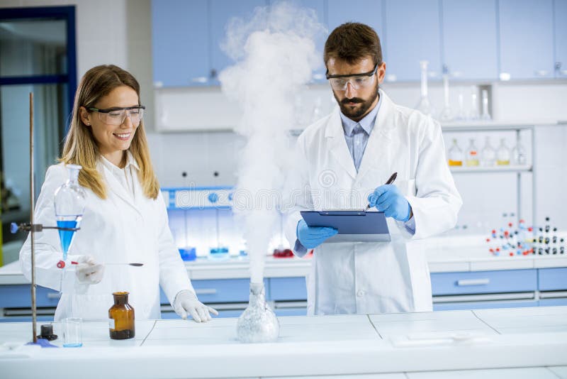 Researchers Doing Experiment with Smoke on a Table of a Chemical ...