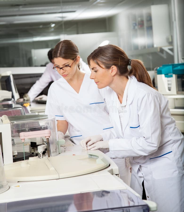 Researchers Operating Machine in Lab Stock Photo - Image of clinic ...