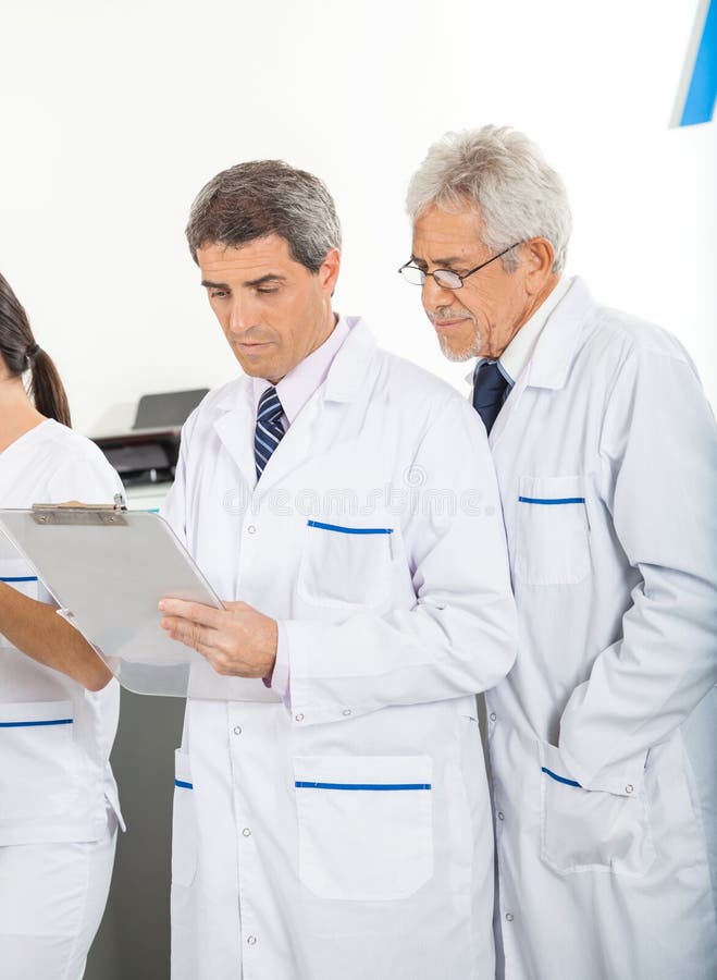 Researchers Reading Clipboard Stock Photo - Image of male, hospital ...