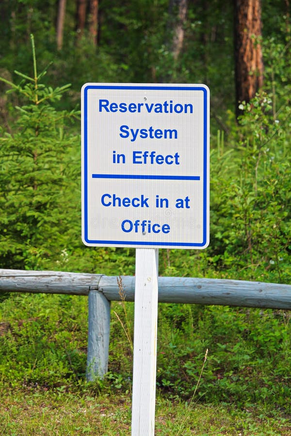 A Reservation System in Effect Sign, Check in at Office Stock Photo ...