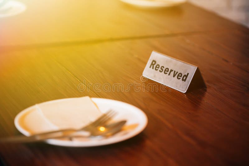`Reserved` Sign on Dining Table in Restaurant with Spoon, Fork and ...
